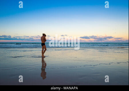 One person walking on the wide beach of Blåvand, Denmark with a ...