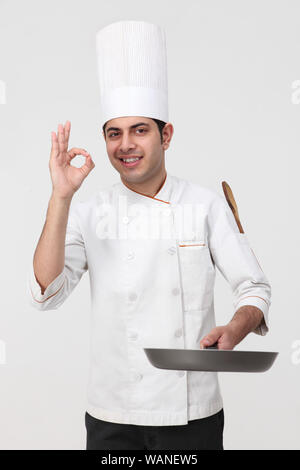 Preparing for perfection. a young man working on a batch of beer in a ...