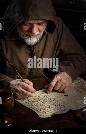 mysterious medieval monk writes letter Stock Photo - Alamy