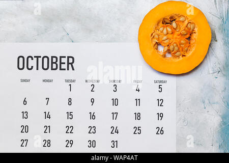 Fall concept. October 2019 Paper Calendar with round slices of pumpkin ...