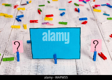 Scribbled and crumbling sheet with paper clips placed on the wooden ...