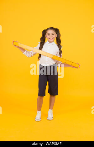 Tell me about distance. Kid school uniform hold ruler. Pupil cute girl ...