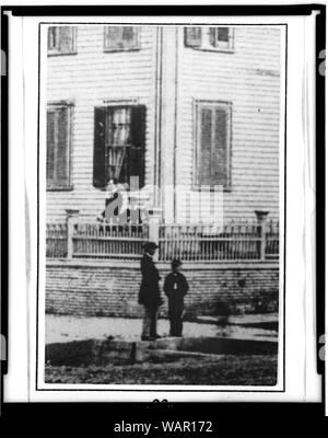 Family standing by fence and looking out over field Stock Photo - Alamy