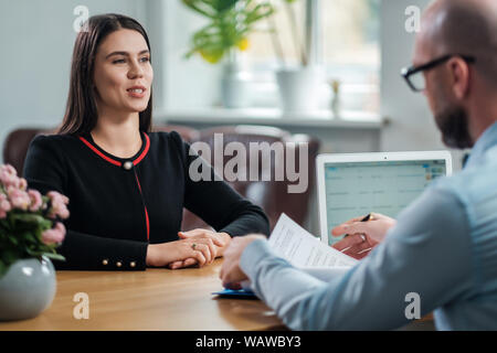 Beautiful brunette woman attending job interview Stock Photo - Alamy