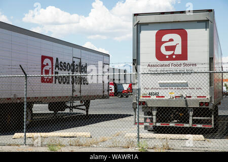 A logo sign outside of the headquarters of Associated Food Stores in ...