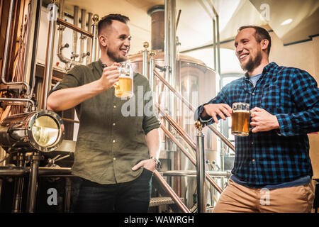 Two men tasting fresh beer in a brewery Stock Photo - Alamy