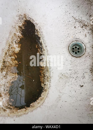 Dirty and disgusting shower drain, close up view. Clogged drain with rust stain, hair. Corrosion ...