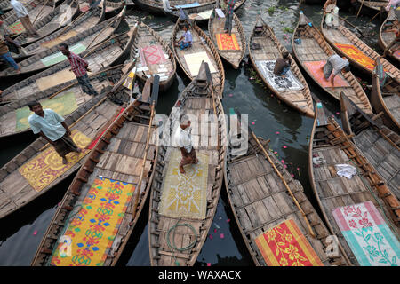 Bangladeshi boatsmen with their traditional boats on Buriganga River ...
