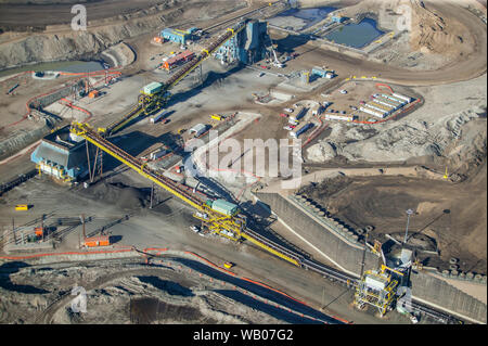Heavy equipment for oil sands industry, red crane and huge digger Stock ...