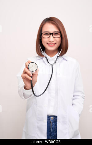 A young Asian doctor holding blood sample test tube on white background ...