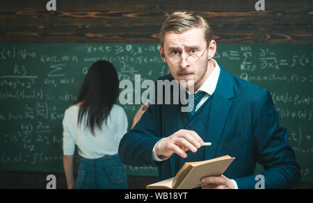 Teacher man using glasses scared in shock, expressing panic and fear at ...