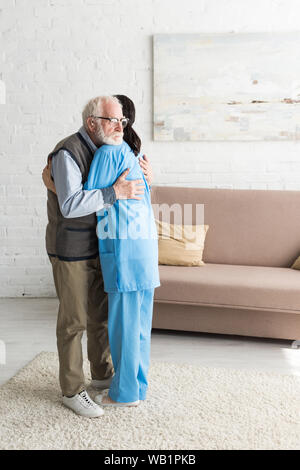 Senior man with grey hair standing over isolated background smiling ...