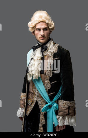 pompous victorian gentleman in wig standing with hand on hip and ...