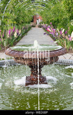 Water feature and wisteria archway at RHS Wisley Gardens, Surrey, UK ...