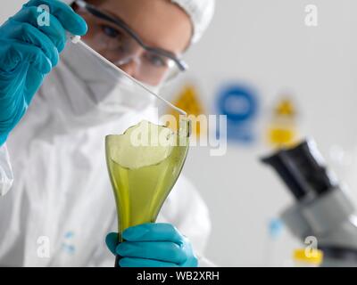Forensic scientist collecting evidence by taking a DNA ...