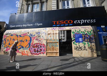 A Tesco Express windows are boarded up in preparation for the Notting ...