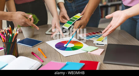 Group of designers choosing color samples together at the table Stock ...