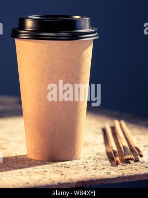 Paint brushes and a cup of coffee on a wooden background, flat lay ...