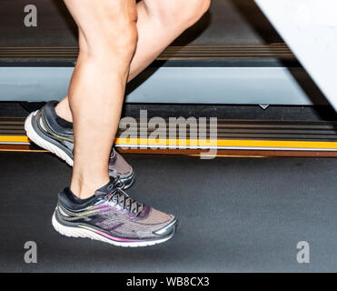 Side view of a girl running legs and feet. Sun lawn Stock Photo - Alamy