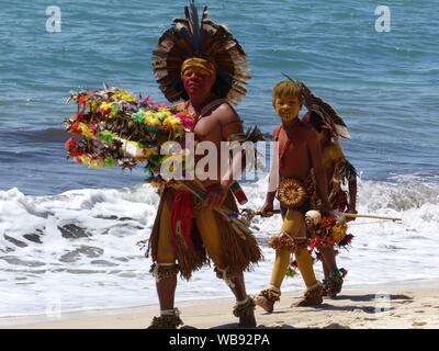 Indigenous Tupiniquim tribe people walking along the Taperapuã beach ...