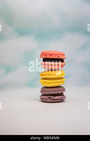 Tasty colourful French macaroon cookies on a red background Stock Photo ...