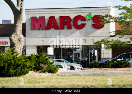 A logo sign outside of a Marc's Stores retail grocery store location in ...