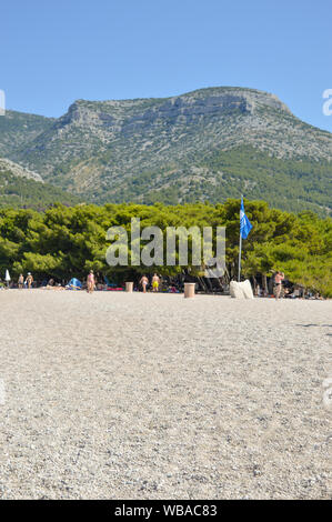 A view of the Adriatic coast with pine trees and a yacht, Brac Island ...