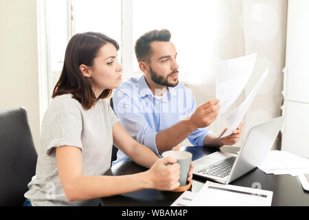 Young family in budget planning concept Stock Photo - Alamy
