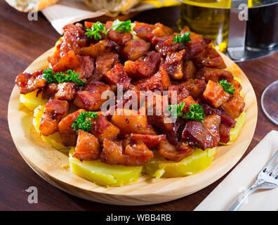 Roasted snouts of pigs with pepper on baked potato - Spanish dish Stock ...