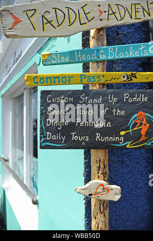 Collection of abstract signs on a timber post in Dingle, County Kerry ...