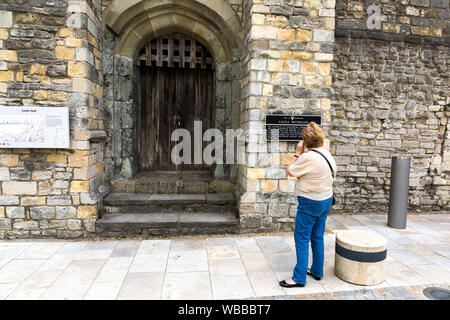 Castle watergate. 14th century gateway. Tourist information plaque ...