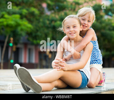 Two smiling sisters spending time in autumn park Stock Photo - Alamy