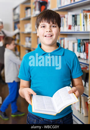 Portrait of happy boy with open book laughing Stock Photo - Alamy