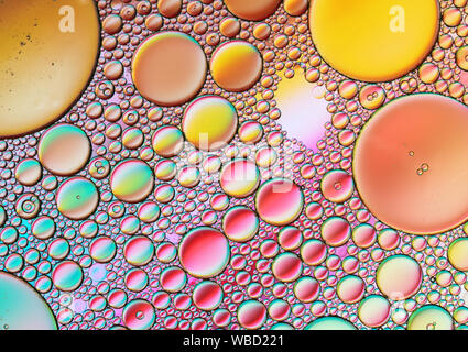 Multi-coloured bubble patterns formed by oil floating on water Stock ...