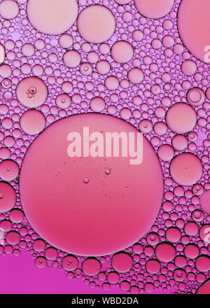 Multi-coloured bubble patterns formed by oil floating on water Stock ...