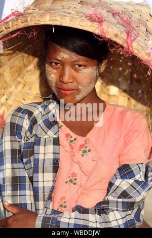 Beautiful young Burmese girl with thanaka yellow paste on cheeks and ...