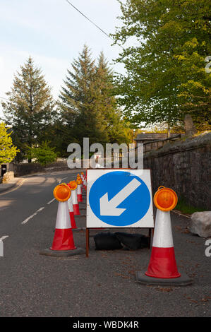 Urban British roadworks & lane closure with cones, watchman barriers ...