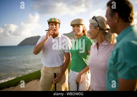 Outdoor photo of female golfer looking at golf course, facing away from ...
