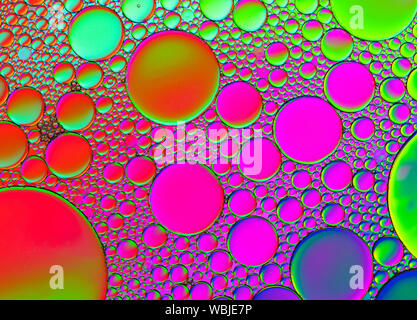 Multi-coloured bubble patterns formed by oil floating on water Stock ...