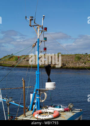 Fishing boat lights on the seaside. The charming crescent moon hangs in ...