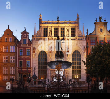 The Artus Court and the Neptune Fountain at night in city of Gdansk in ...