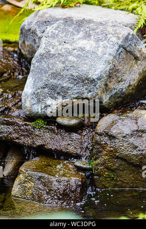 Water trickling down rock face outdoors Stock Photo - Alamy