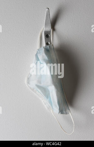 Protective medical mask hanging on the gear lever of an automatic ...