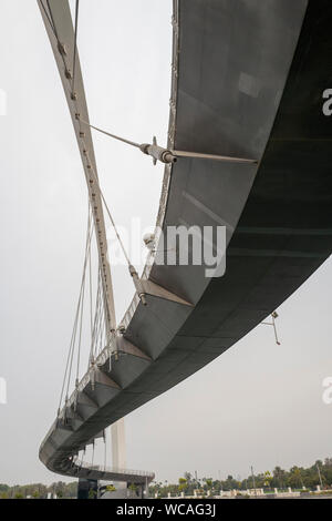 Curved footbridge over a canal in nature reserve Stock Photo - Alamy
