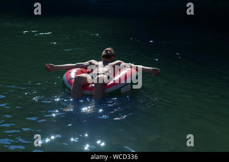 People relaxing on inflatable floats in pool at Aquaventure Waterpark ...