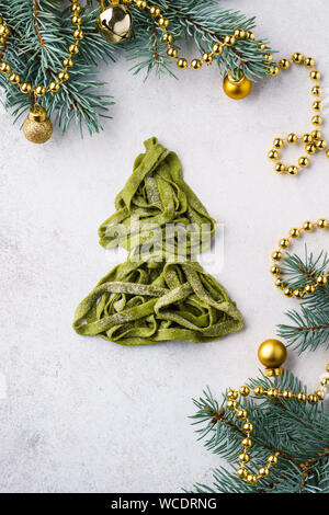 Layout made of Christmas tree branches on blue background. Flat lay ...