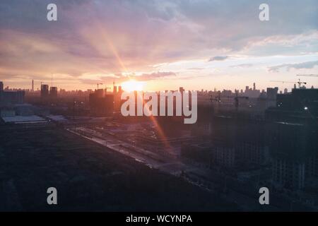Sun shining over a city Stock Photo - Alamy