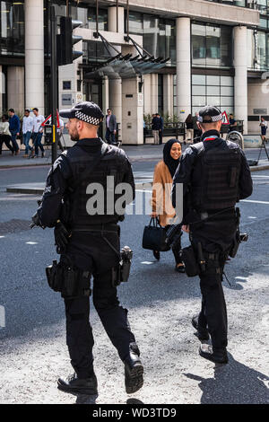 Armed City of London police officers patrol the capital's street's ...