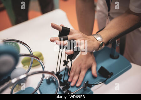 Details with the hand of a woman kinetotherapy medic (physical ...