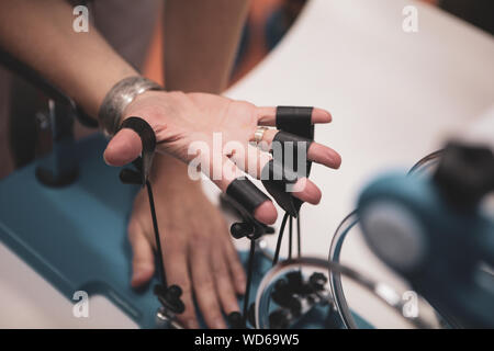 Details with the hand of a woman kinetotherapy medic (physical ...